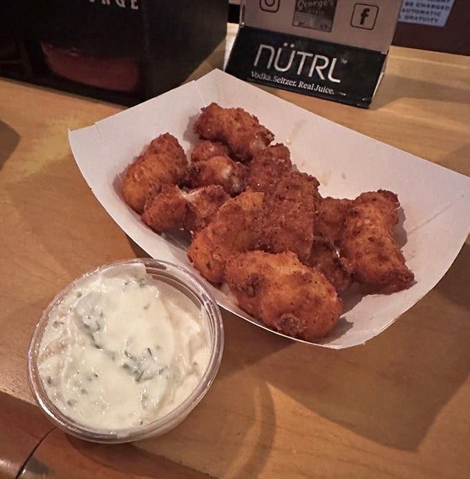 These aren't just cheese curds; they're little nuggets of joy that traded their squeak for a perfect golden crunch. The dipping sauce is merely a bonus round.