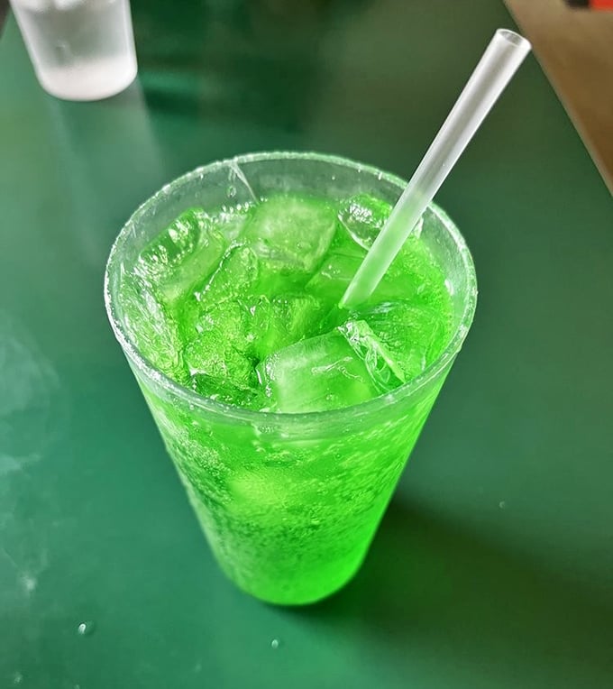 That electric green isn't a special effect—it's the legendary Green River soda, tasting like lime-flavored nostalgia in a glass that demands to be photographed.