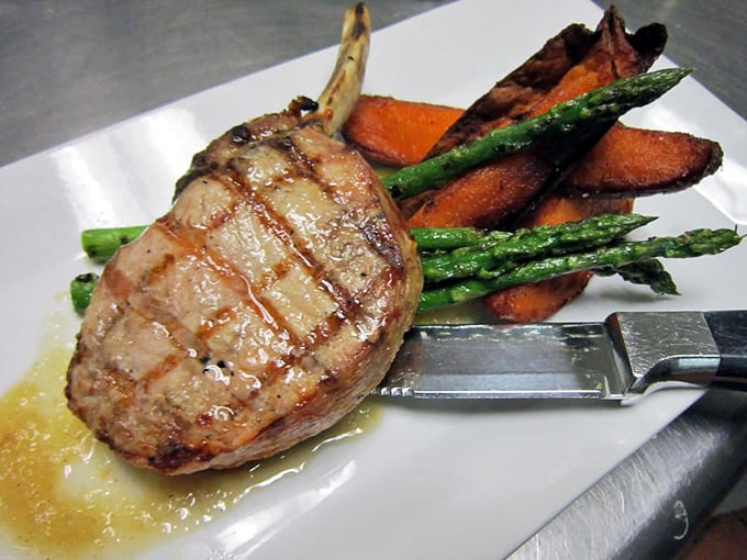 This pork chop has been kissed by fire and blessed with asparagus. The sweet potatoes are just along for the delicious ride.