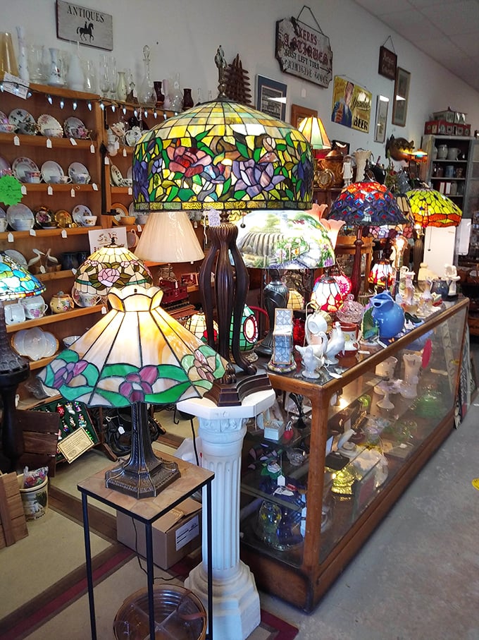 Tiffany-style lamps create pools of colored light across the store – functional art that transforms any room into a stained-glass sanctuary.