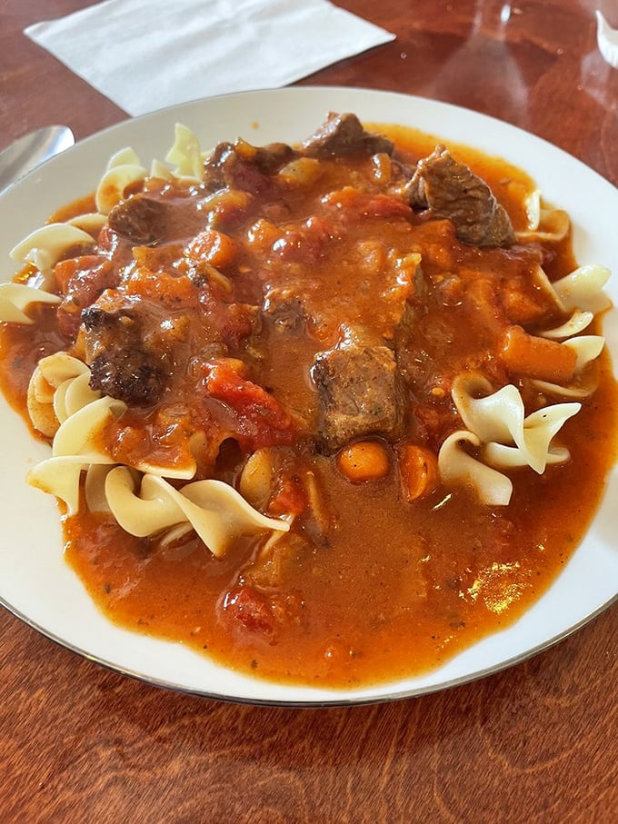 Hungarian goulash over egg noodles—where tender beef and paprika-rich sauce create the kind of meal that makes you cancel your evening plans.