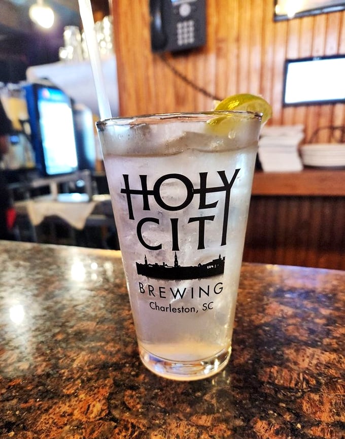 A Holy City Brewing glass stands tall and proud, condensation beading like morning dew—Charleston in liquid form.
