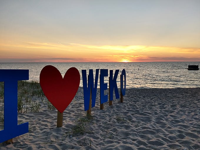 The "I ❤️ WEKO" sign captures what happens to visitors after just one sunset here – instant, irrevocable beach romance.