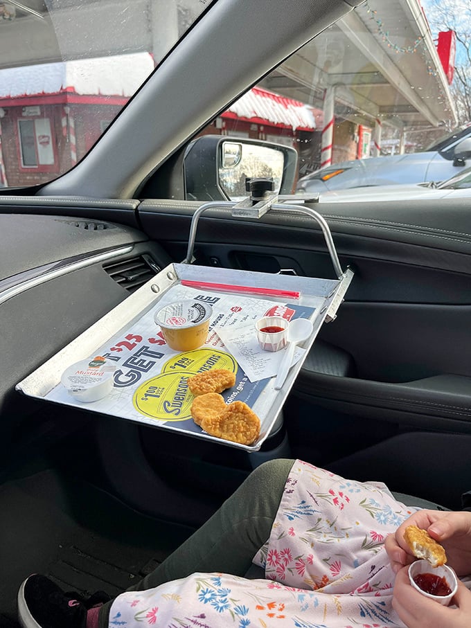 The ingenious window tray transforms your driver's side door into prime restaurant real estate—mid-century innovation that still feels revolutionary today.