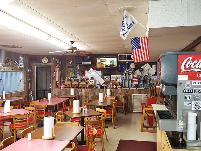 American flags and Texas pride decorate walls that have absorbed decades of BBQ stories – if only these corrugated panels could talk.