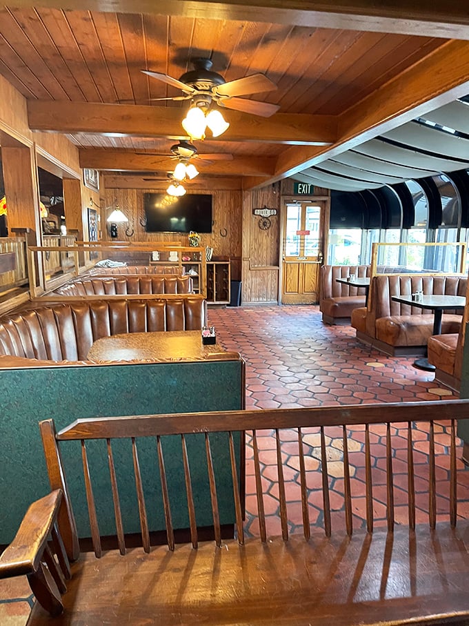 Another angle of the dining room reveals the thoughtful layout—comfortable booths, warm lighting, and a brick floor that's supported countless celebrations.