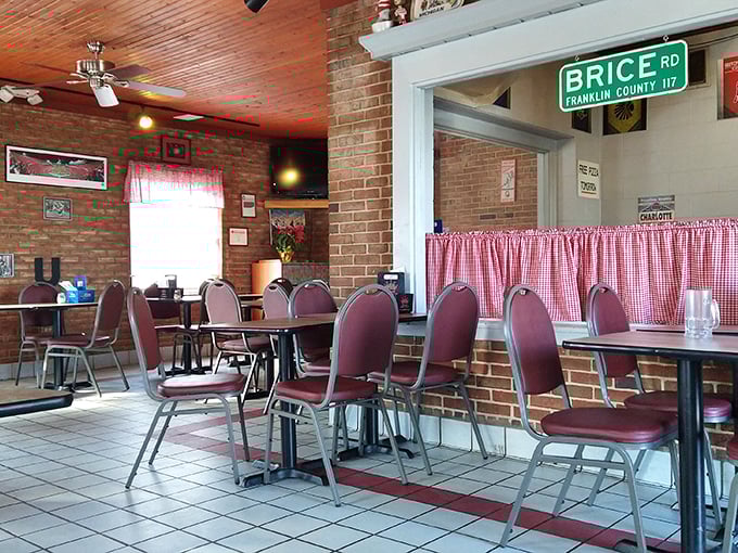Red-checkered curtains and burgundy chairs—the dining room feels like it was designed by your Italian grandmother, in the best possible way.