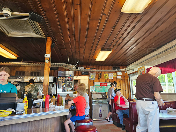 The warm wood interior doesn't just house a restaurant—it shelters decades of community memories and the kind of conversations that only happen over great food.