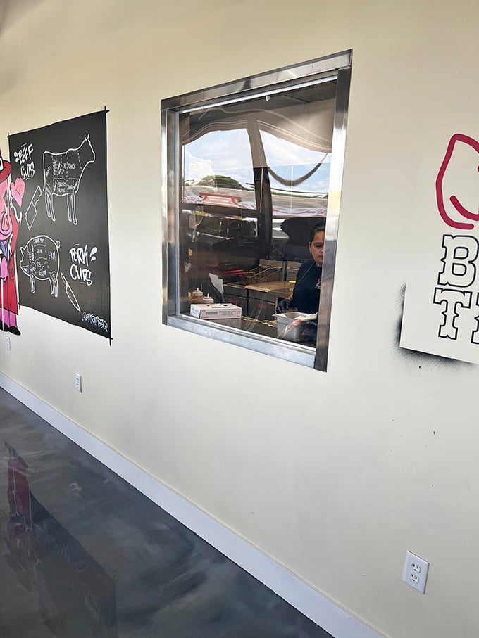 The window to the soul of B&D Trap – where smoke meets skill. The wall art reminds you that barbecue isn't just food, it's an education in delicious anatomy.