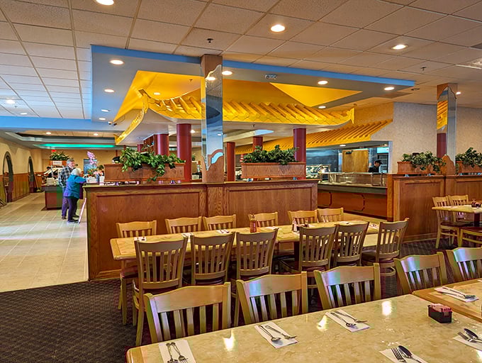 The spacious dining area with its yellow ceiling details creates an atmosphere where you can focus on what matters—multiple trips to those buffet stations.