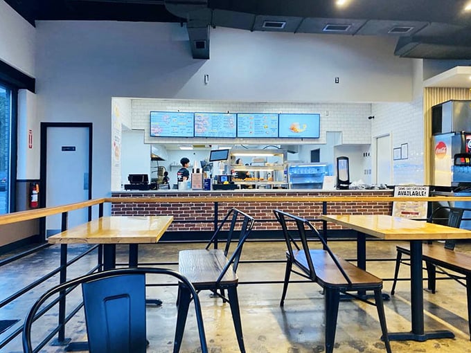The ordering counter beckons with promises of crispy delights, while the open kitchen offers tantalizing glimpses of the magic happening behind the scenes.