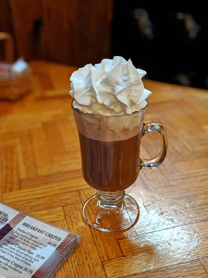 Hot chocolate elevated to art form—that whipped cream crown making you wonder if drinking dessert for breakfast is actually the smartest move.
