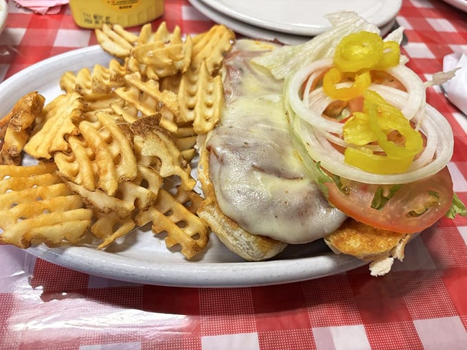 A burger that doesn't need pretension, just melty cheese and fresh toppings, with waffle fries that crunch like autumn leaves.