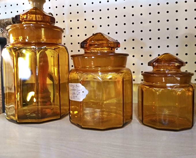 Amber glass jars that once held everything from cookies to buttons now wait for your modern treasures. Their warm glow is like sunset captured in glass.
