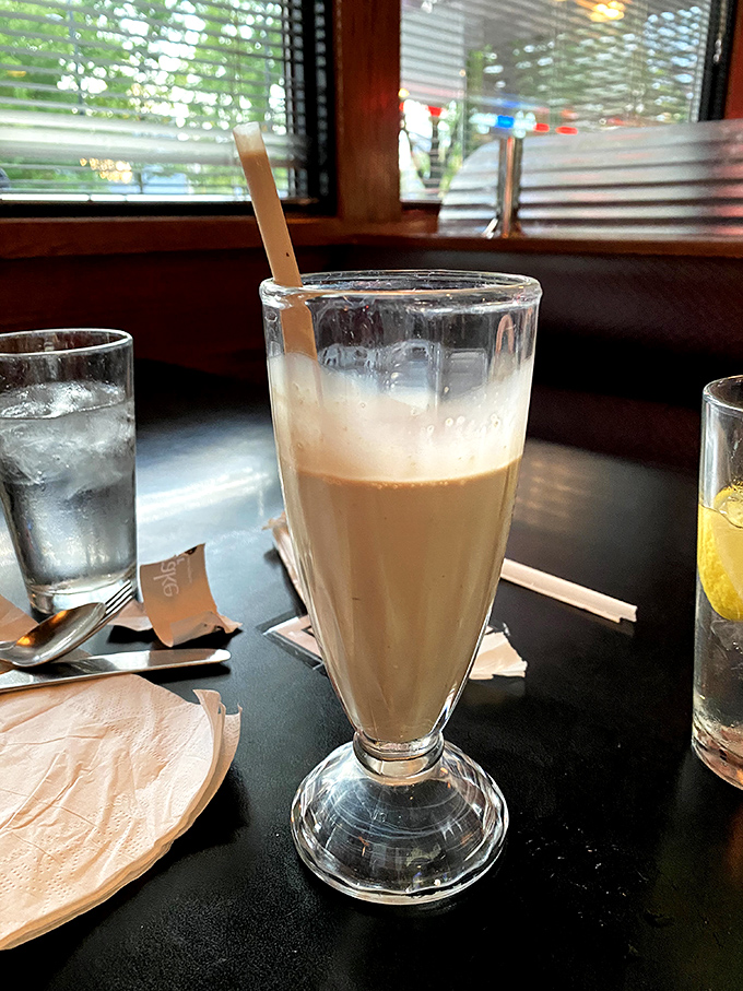 The chocolate malt arrives with that nostalgic paper straw wrapper – a sweet sip of yesteryear that Instagram filters try desperately to replicate.