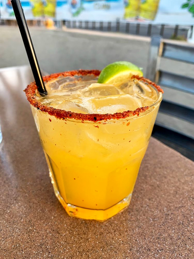 A margarita with a spicy rim that's like a tiny vacation in a glass. That lime wedge isn't garnish—it's an essential supporting actor.