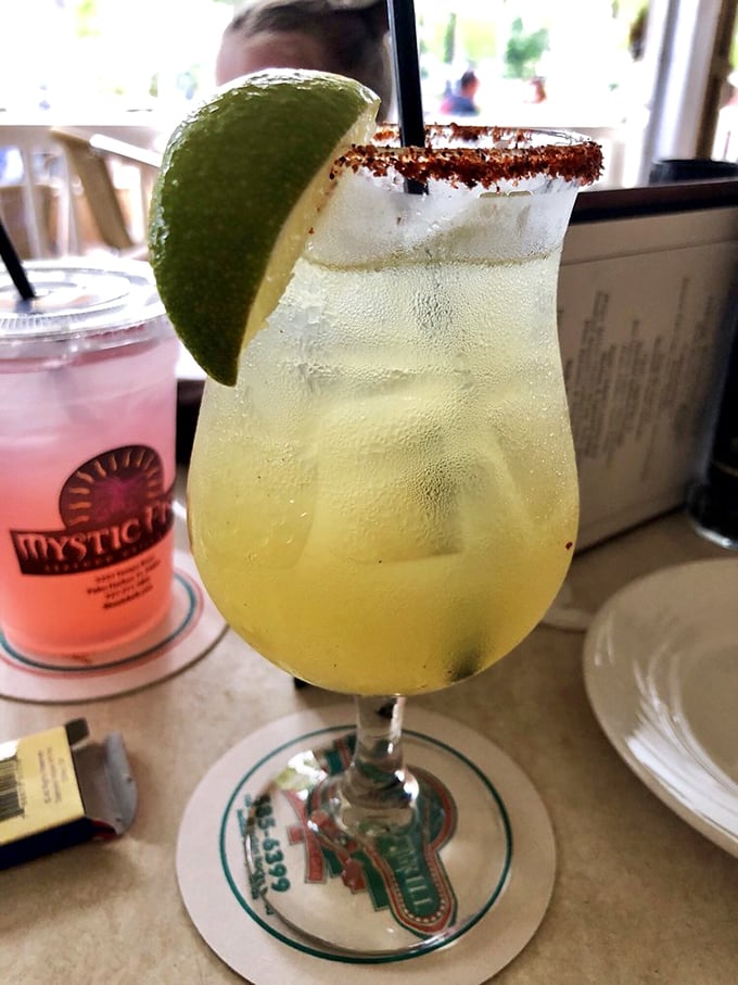 A margarita with the perfect salt rim and lime wedge—the kind of drink that makes you wonder why you don't live at the beach year-round.