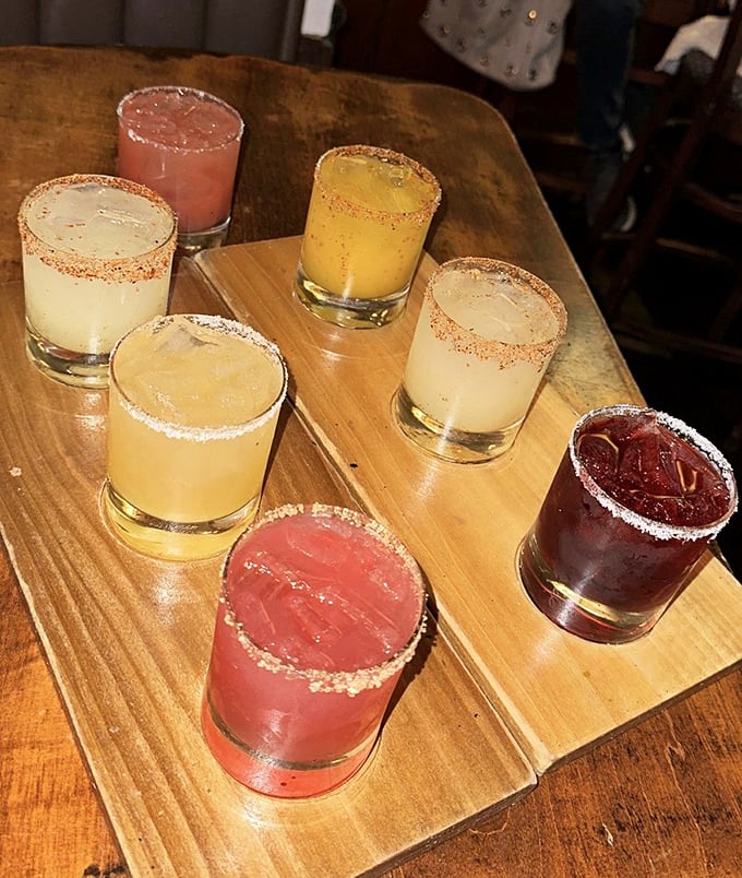 A rainbow of margaritas that promises flavor adventures beyond the standard lime—liquid vacation samplers with salt-rimmed sophistication.