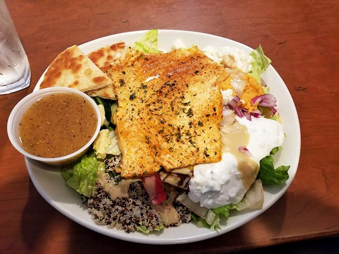 This Mediterranean bowl proves healthy eating doesn't mean flavor sacrifice—that perfectly cooked salmon deserves its own fan club.