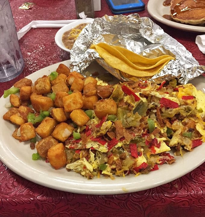 Breakfast with attitude: potatoes crisped to perfection alongside a colorful scramble that's like the Texas landscape on a plate—vibrant, varied, and satisfying.