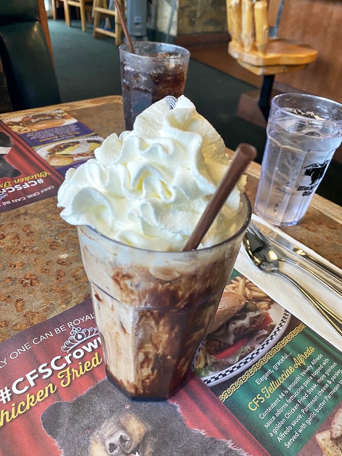This isn't just a milkshake—it's a skyscraper of whipped cream atop a foundation of creamy, chocolatey bliss. Spoon and straw required.
