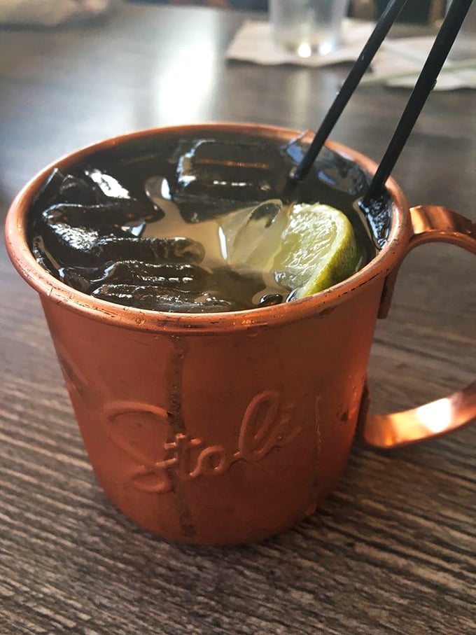 The Moscow Mule arrives in its proper copper vessel—cold, refreshing, and looking like it belongs in the hand of someone making better life choices than you.