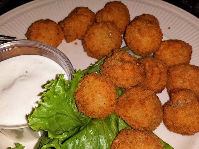 Golden-fried mushrooms that crunch like autumn leaves, with a dipping sauce that makes you forget vegetables were ever considered boring.
