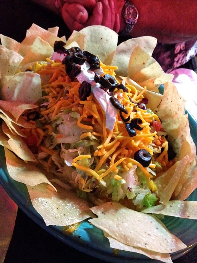 The taco salad arrives like an edible art installation – a crispy tortilla bowl cradling layers of Tex-Mex goodness that's as photogenic as it is delicious.