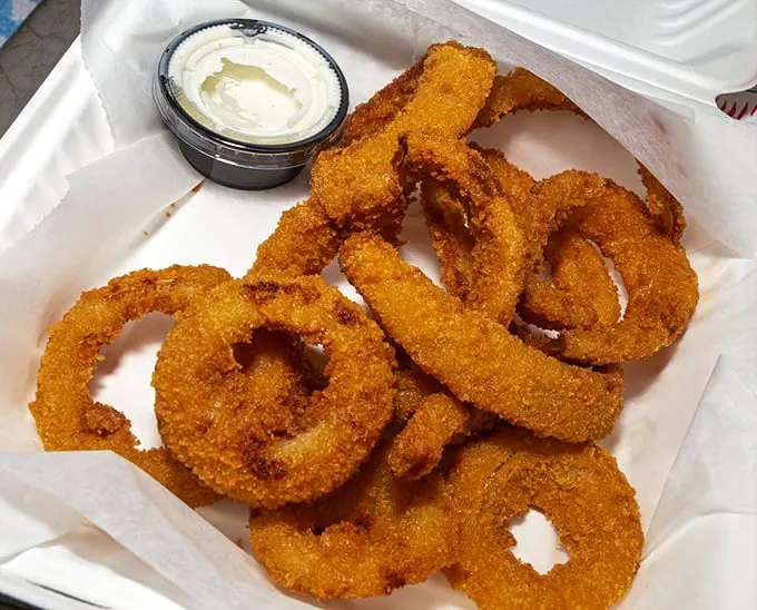 Onion rings with a crunch that announces itself to the entire restaurant. Worth every awkward "yes, I'm enjoying this" nod to nearby tables.