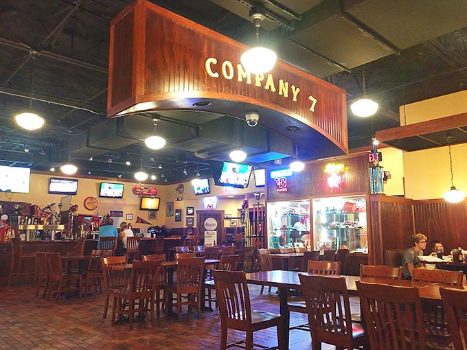 The wooden "Company 7" sign watches over diners like a benevolent BBQ deity. This isn't just eating—it's a communal experience with TVs for company.