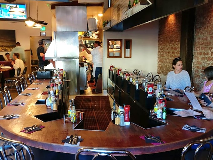 The counter seating offers front-row tickets to the breakfast show. Those condiment bottles aren't decorative—they're essential supporting actors.