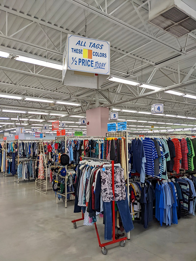 Half-price tag day brings the thrill of the hunt to new levels, with signs overhead guiding bargain seekers to their next great find.