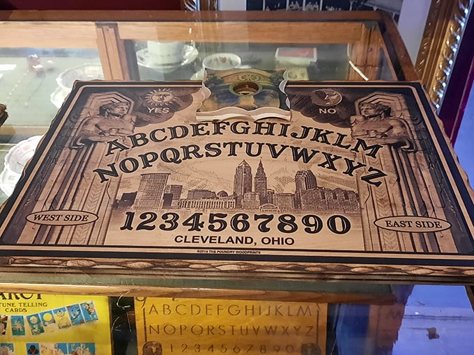 A Cleveland-specific Ouija board features the city skyline—because even spirits need local landmarks to navigate by. "East Side or West Side?" is apparently a question for all realms.