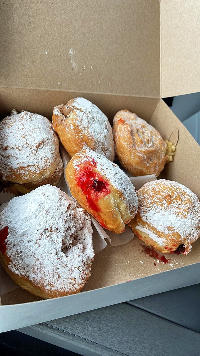 Powdered jelly donuts with that telltale red center—the pastry equivalent of a surprise plot twist you can actually see coming.