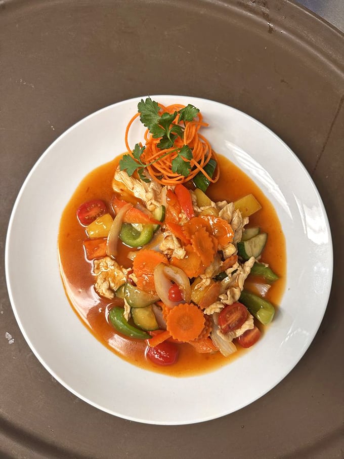 A symphony of colors and textures in this Pad Priew Wan. The sauce is doing the backstroke around islands of vegetables and protein—vacation on a plate.