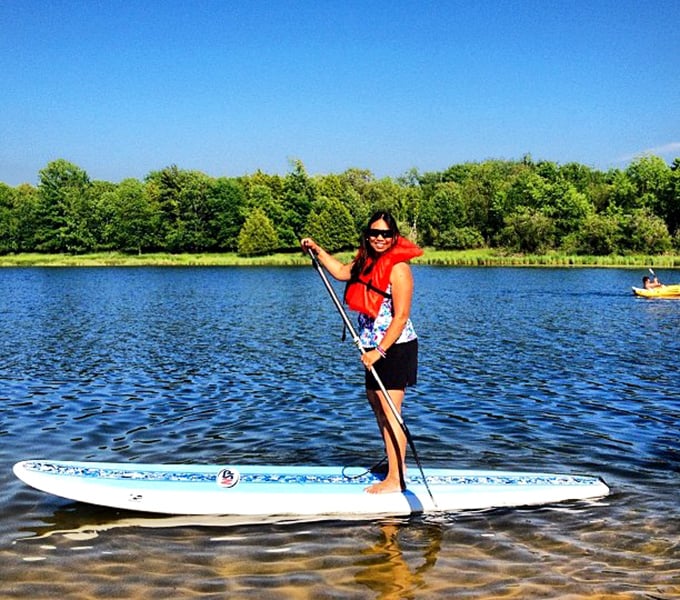 Stand-up paddleboarding: the perfect combination of looking graceful and feeling terrified of falling in. Lake waters so clear you can count fish judging your technique.