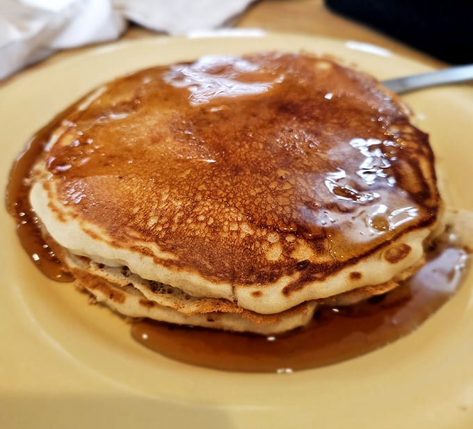 These pancakes aren't just golden brown – they're the color of childhood Saturday mornings and adult breakfast victories.