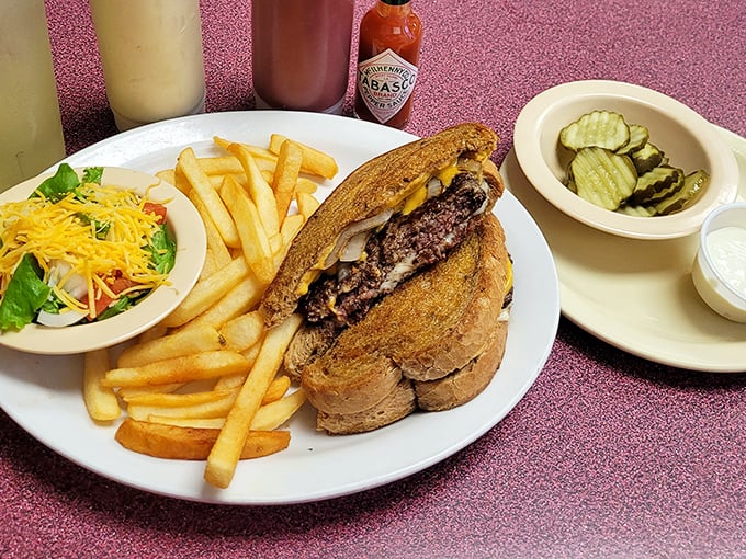 The patty melt – that brilliant marriage of burger and grilled cheese – flanked by crispy fries and a token salad for "balance."