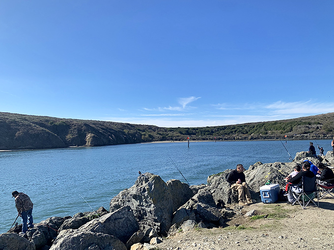 The patience of fishermen meets the drama of coastal cliffs – a scene unchanged for generations except for the coolers that now hold the beer.