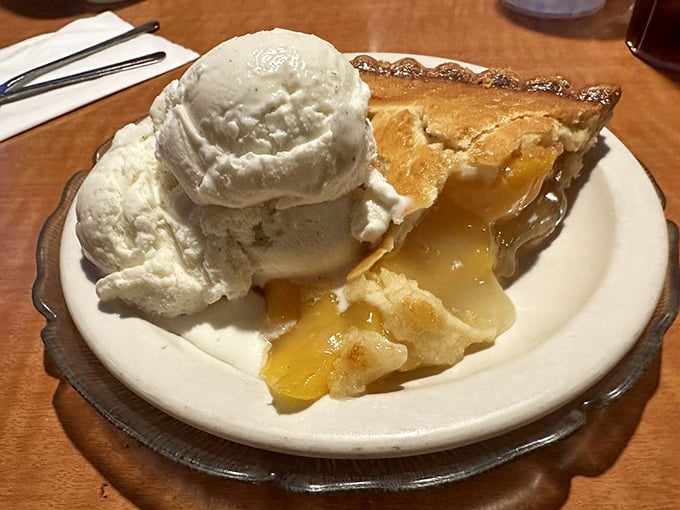 Apple pie that doesn't just arrive à la mode—it arrives with ice cream melting into warm filling like it's auditioning for a dessert commercial.