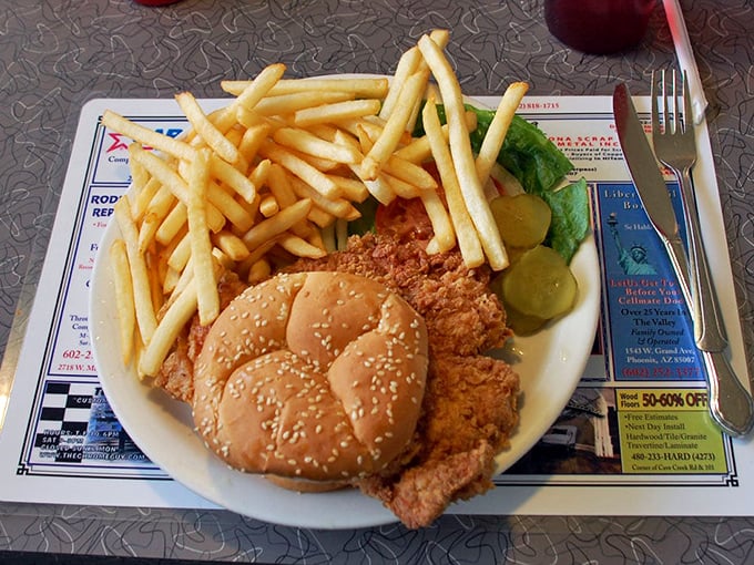The classic diner trifecta: crispy golden fries, a perfectly breaded pork loin sandwich, and pickles for that essential tangy counterpoint.