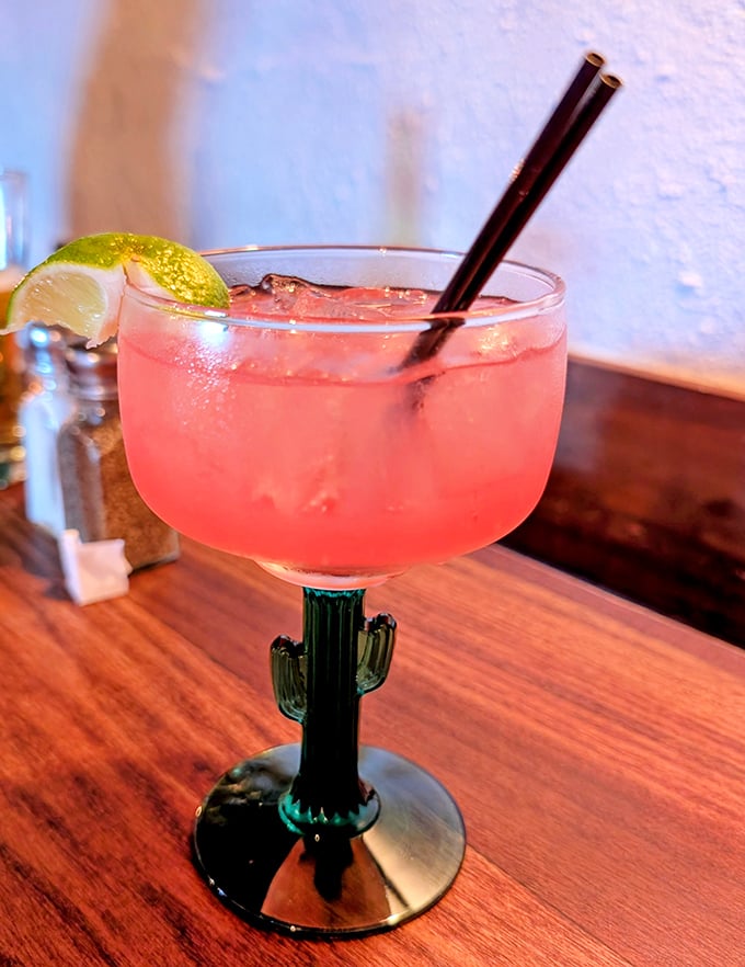 The prickly pear margarita—where desert fruit meets tequila in a glass that screams "vacation mode activated." That cactus stem is Arizona's version of a tiny umbrella.