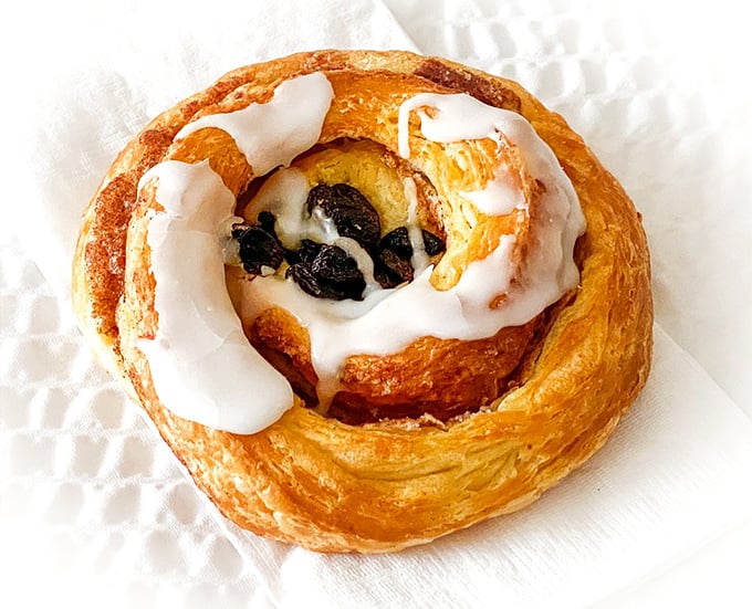 A spiral of buttery dough and cinnamon, topped with icing that melts just enough to create that perfect sweet-to-pastry ratio.