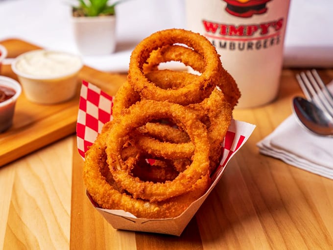 Onion rings stacked like golden halos – crispy, substantial, and demanding to be the main event rather than a mere side dish.