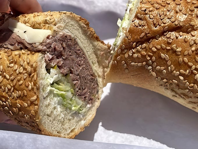 This cross-section reveals the roast beef hoagie's inner workings—a carefully engineered ratio of meat, cheese, and vegetables that defies gravity.
