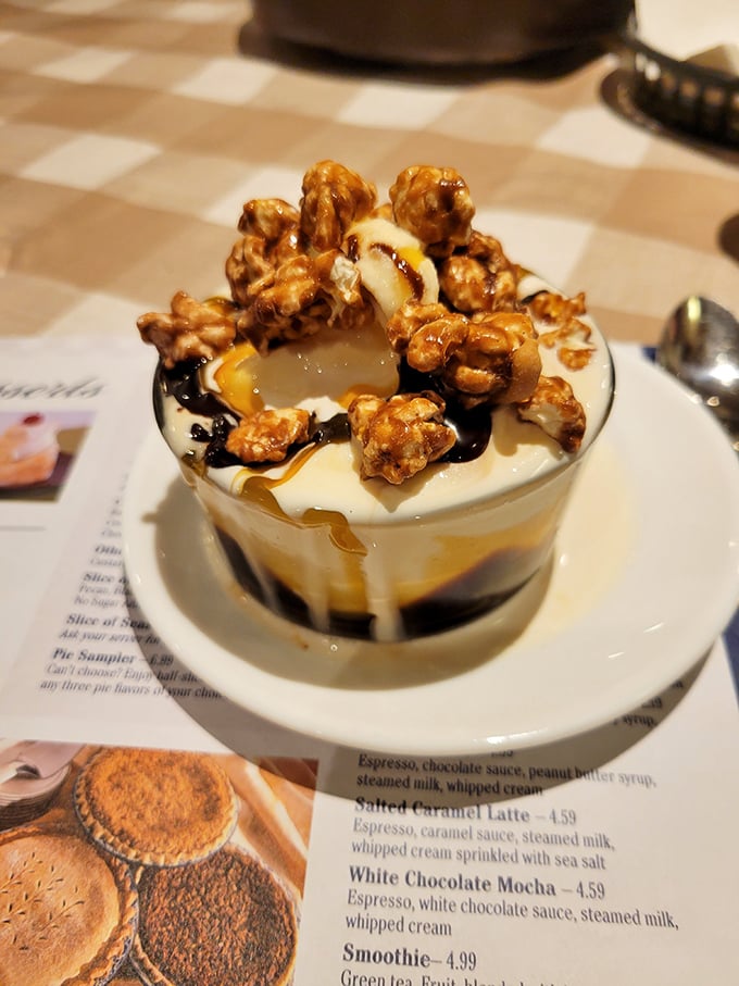 Not just dessert—it's a work of art. This caramel-drizzled creation with candied popcorn makes ordinary sundaes seem like a sad compromise.
