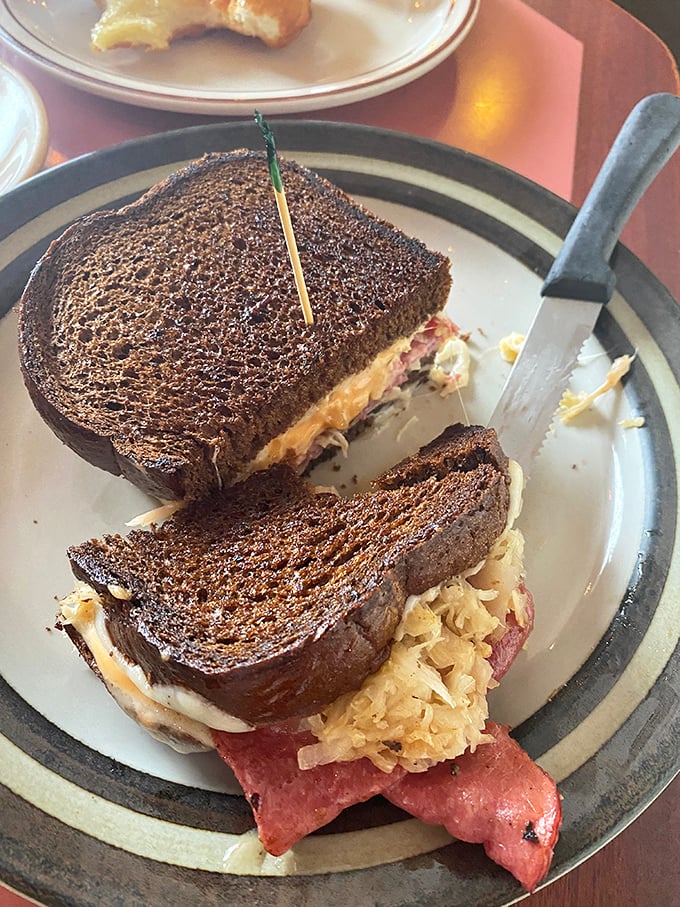 A perfectly grilled sandwich with what appears to be corned beef and sauerkraut—the kind that makes you wonder why you ever eat anything else.