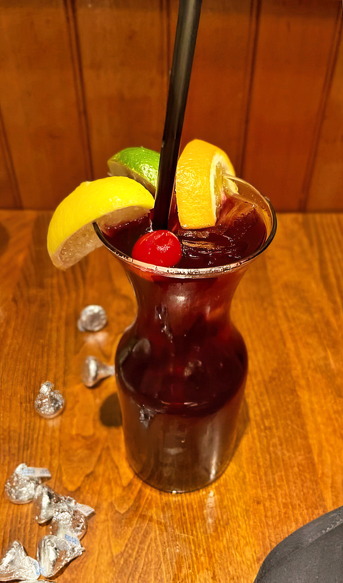 A cocktail that's dressed better than most wedding guests. This sangria, adorned with citrus wheels and a cherry, promises fruity refreshment.