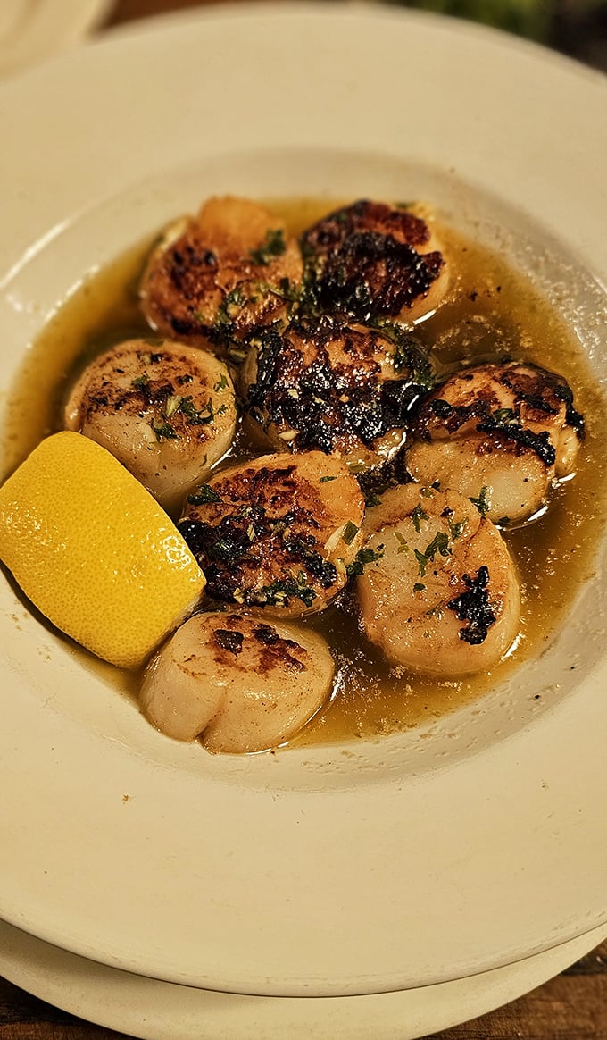 Scallops seared to golden perfection, swimming in buttery bliss—proof that this steakhouse respects the treasures of the sea equally.