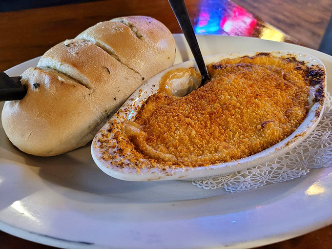 "This seafood au gratin arrives bubbling hot with a golden crust that practically begs you to break through to the creamy treasure below."